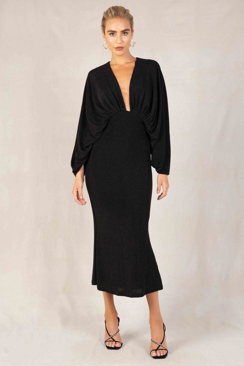 The Rica Dress features a deep V neckline, batwing sleeves
